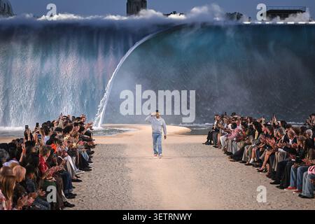 US designer Pharrell Williams cheers the attendees at the end of the ...