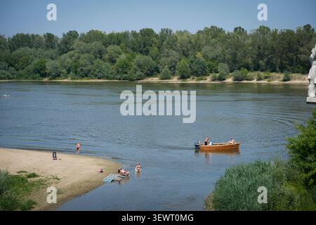 People cool off in a river as the National Weather forecaster issued an ...