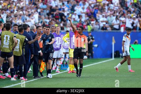 referee Jalal Jayed shows a yellow card to Kai Havertz of Germany ...