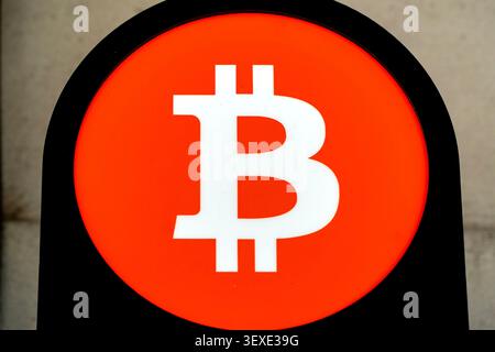 Cryptocurrency logos are displayed on an ATM machine in Tbilisi ...