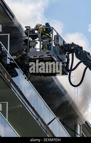 Firefighters pictured at the scene of a fire in an apartment building ...