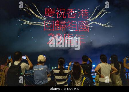 People watching a drone show to mark 29 years after the handover of ...