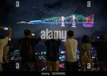 People watching a drone show to mark 29 years after the handover of ...