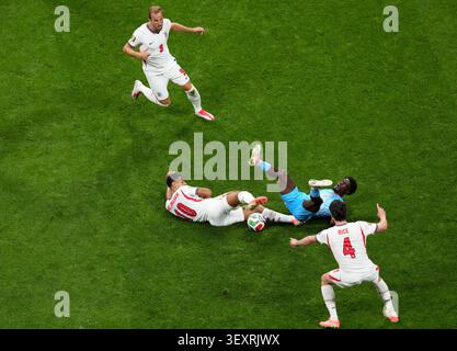 Jude Bellingham of England and Nathanael Mbuku of Congo DR challenge ...