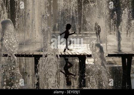 July 1, 2026, Kadikoy, Istanbul, Turkey: Children cool off under water ...