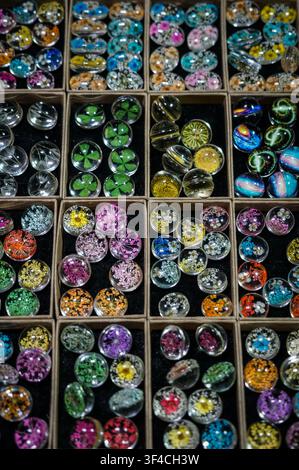 A close up view shows multiple small round paper lanterns in various ...