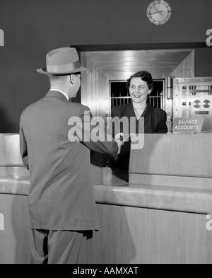 1950s BANK TELLER WOMAN MAN PARTITION FINANCE MONEY SUIT HAT Stock ...