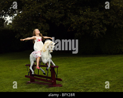 Girl smiling on rocking horse in playground Stock Photo: 72118720 - Alamy