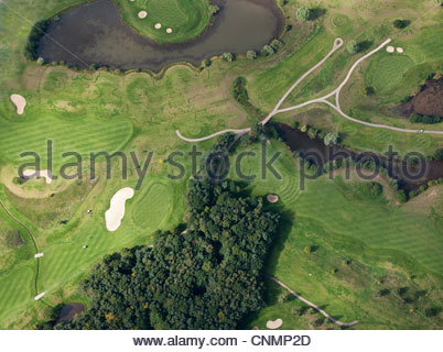 Aerial view of golf course fairway and green with sand traps, pond ...