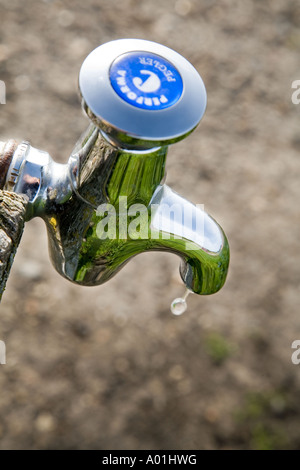 Chrome stand pipe public tap dripping water Stock Photo - Alamy