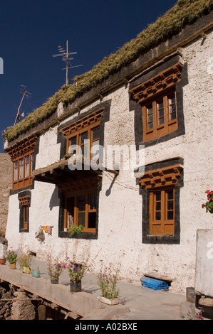 Traditional Ladakhi house with white-washed walls and blue windows in ...