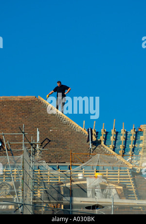 a roofer at work on a building, roof work and construction roofer at ...
