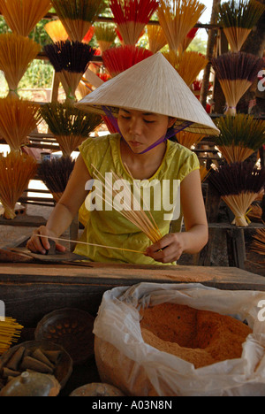 Workers of traditional incense-making factory in a village on the ...