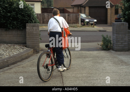 teenage boy delivering papers on his bike Stock Photo - Alamy