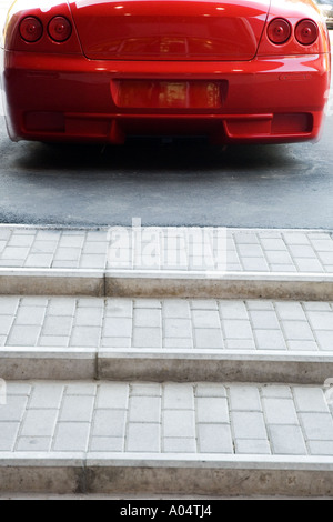 Red sports car model rear view on white background Stock Photo - Alamy