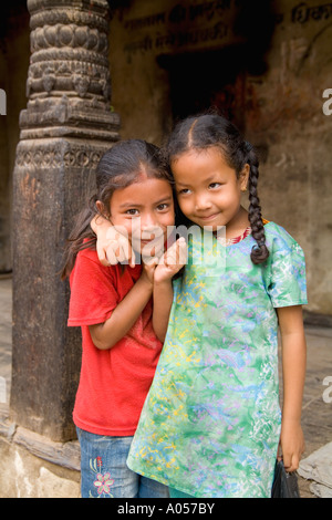 Beautiful young children laughing aged 6 and 7 having fun in village of ...