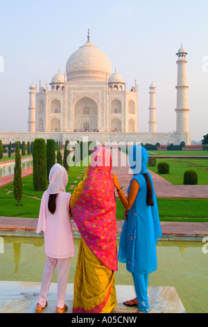 Hindu women with colorful veils in the quiet peaceful Taj Mahal one of ...