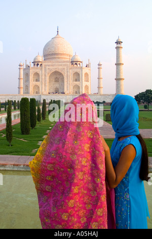Hindu women with colorful veils in the quiet peaceful Taj Mahal one of ...
