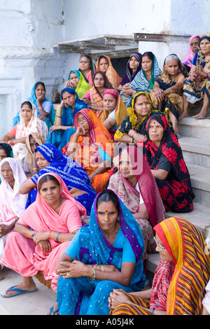 Hindu women with colorful veils in the quiet peaceful Taj Mahal one of ...