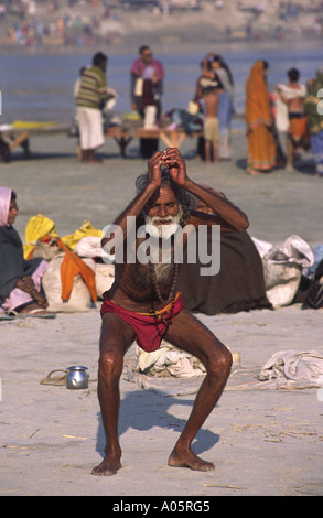 Sadhu, Holy Man, practicing yoga opposite the burning ghats Stock Photo ...