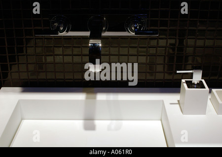 A luxurious bathroom, metal sink, and faucet, large mirror with ...
