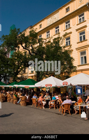 People dining at open air pubs and restaurants on the Main Square in ...