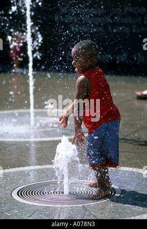 A boy plays in a water fountain at the Fundidora Park in Monterrey ...