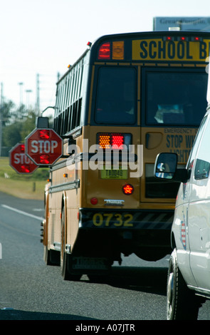 School bus with stop signs showing for unloading and loading students ...