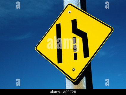 Yellow and black diamond-shaped merge road sign Stock Photo - Alamy