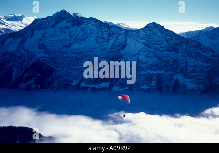 Parasailer gliding over Bernese Alps, winter, Switzerland Stock Photo ...