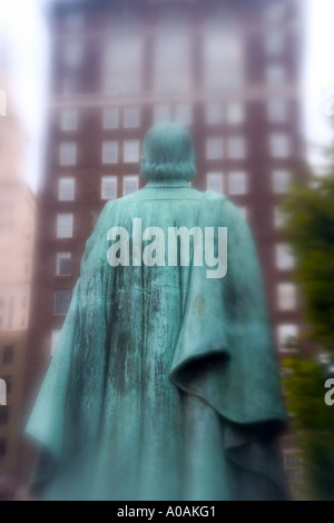 Back of a statue which is facing a downtown office building Stock Photo ...
