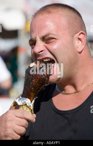 Portrait Caucasian man eating turkey leg Stock Photo - Alamy