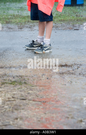Portrait Caucasian boy getting drenched in storm Stock Photo - Alamy