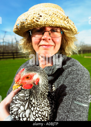 Woman with chicken in her arms Stock Photo - Alamy