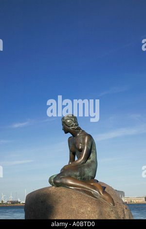 The bronze sculpture of The Little Mermaid sits on a large rock close to the shore by the cruise ...