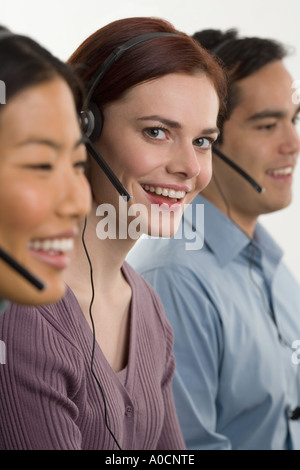 Portrait of colleagues using headsets Stock Photo - Alamy
