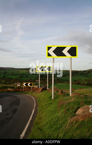 Road Direction Chevron signs on a left hand corner, in Yorkshire Stock ...