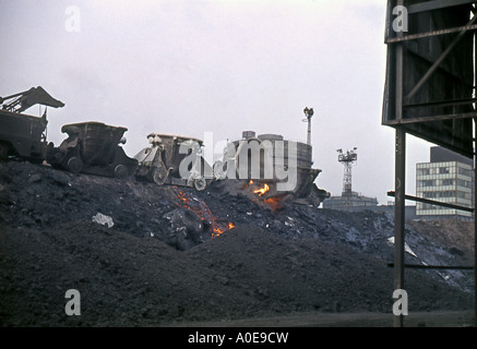 Slag ladles in use dumping waste molten slag onto slag banks for ...