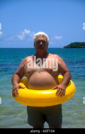 Heavy man at tropic beach standing still in water Stock Photo - Alamy