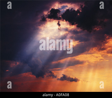 DRAMATIC SKY WITH CLOUDS AND SHAFT OF SUNLIGHT OVER GLISTENING SEA ...