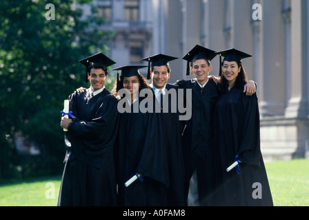 Two female graduates and three male graduates holding diplomas Stock ...