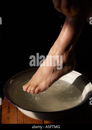 washing feet in an old enamel bowl Stock Photo - Alamy