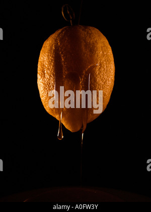 lemon with honey on a black ground Stock Photo - Alamy