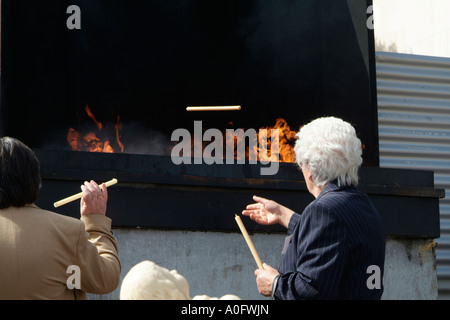 People throwing candles to the fire in Fátima Sanctuary in Portugal ...