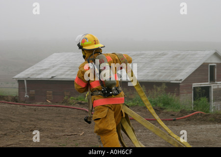 Firefighter Stretching Hose Line Stock Photo - Alamy