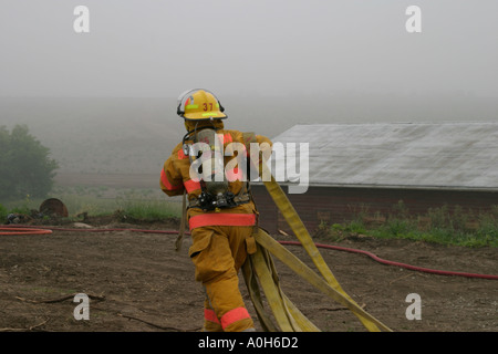 Firefighter Stretching Hose Line Stock Photo - Alamy
