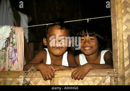 happy asian family with two children sitting on couch at home watching ...