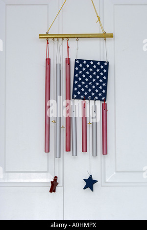 American flag wind chimes hanging on a white entry door Stock Photo - Alamy