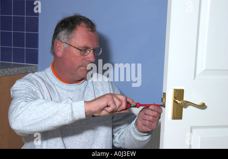 Man Fitting Door Handle Inside House Stock Photo - Alamy