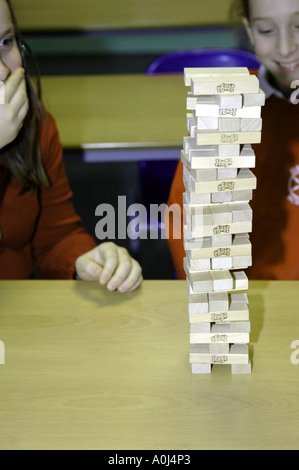 girls playing jenga wooden wood game Stock Photo - Alamy